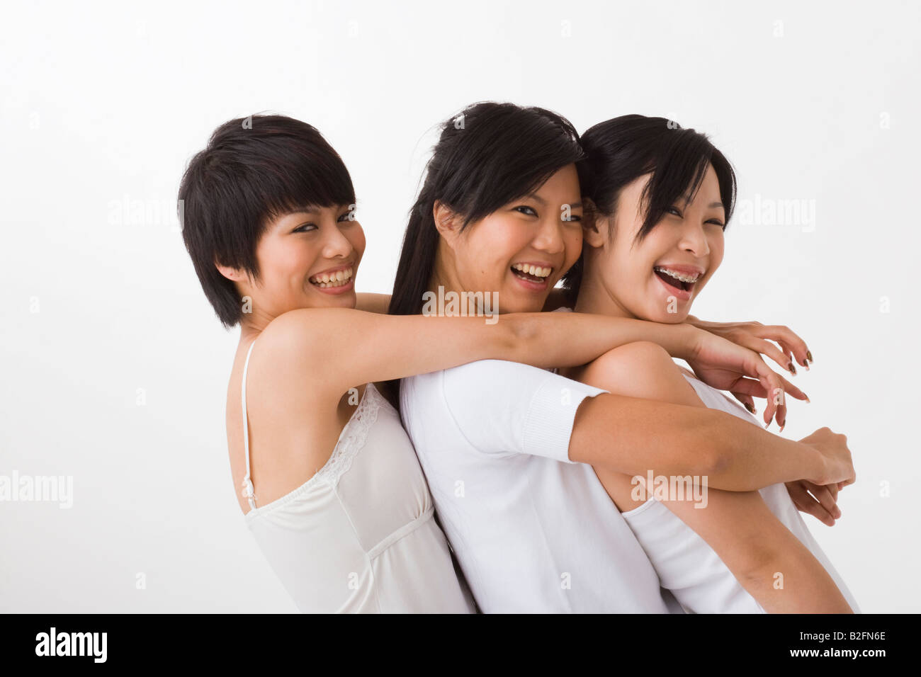 Portrait of three young women smiling Stock Photo - Alamy