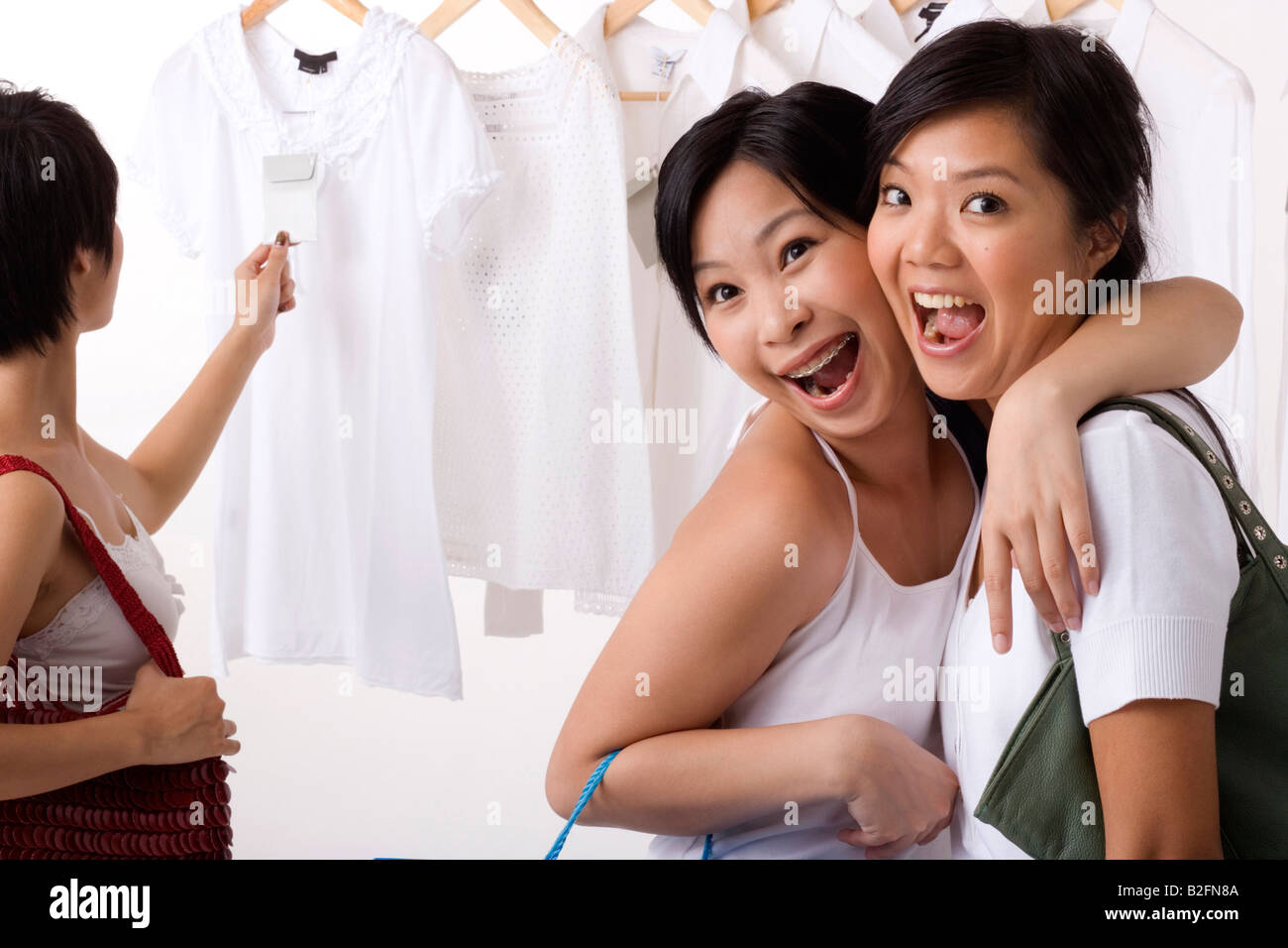 Female friends holding dresses at store hi-res stock photography and ...