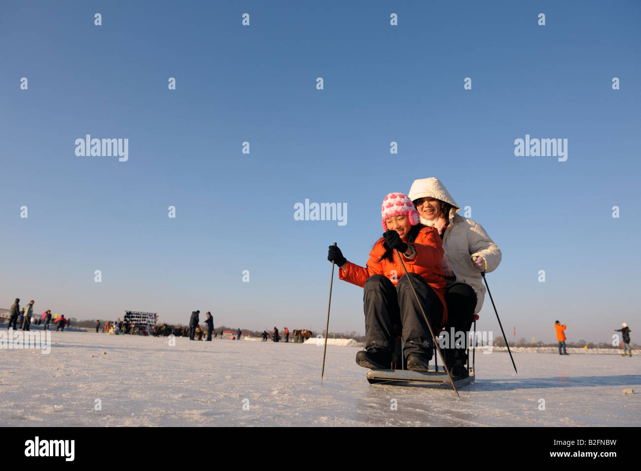 Chinese tourists riding a sled on the frozen Songhua River, Harbin ...