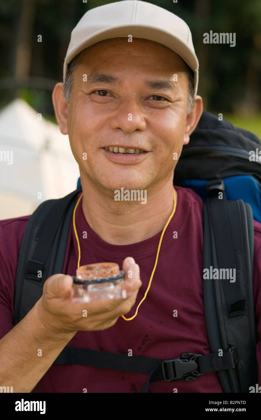 Portrait of a mature man holding a compass and smiling Stock Photo - Alamy