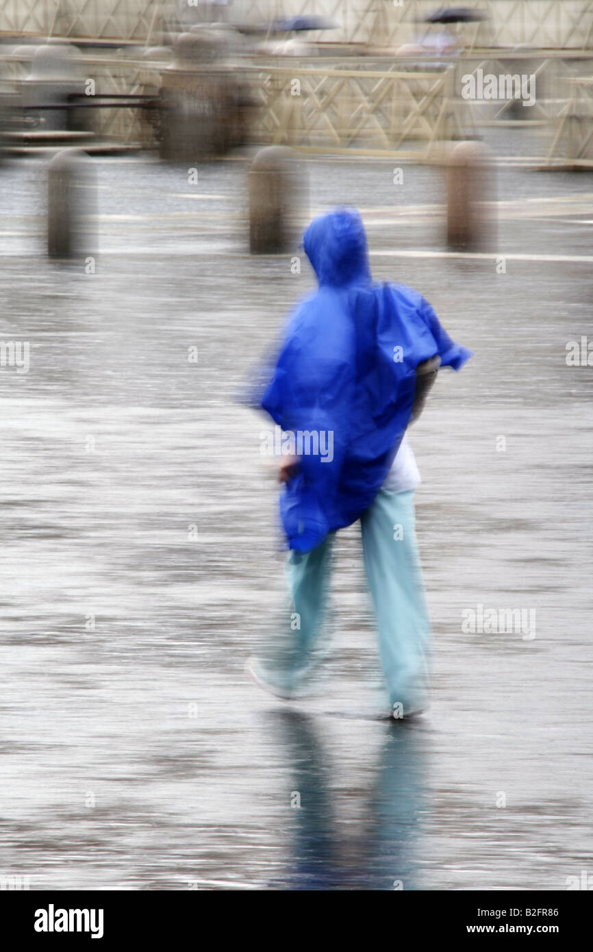 person wearing waterproof coat cape in rain Stock Photo - Alamy