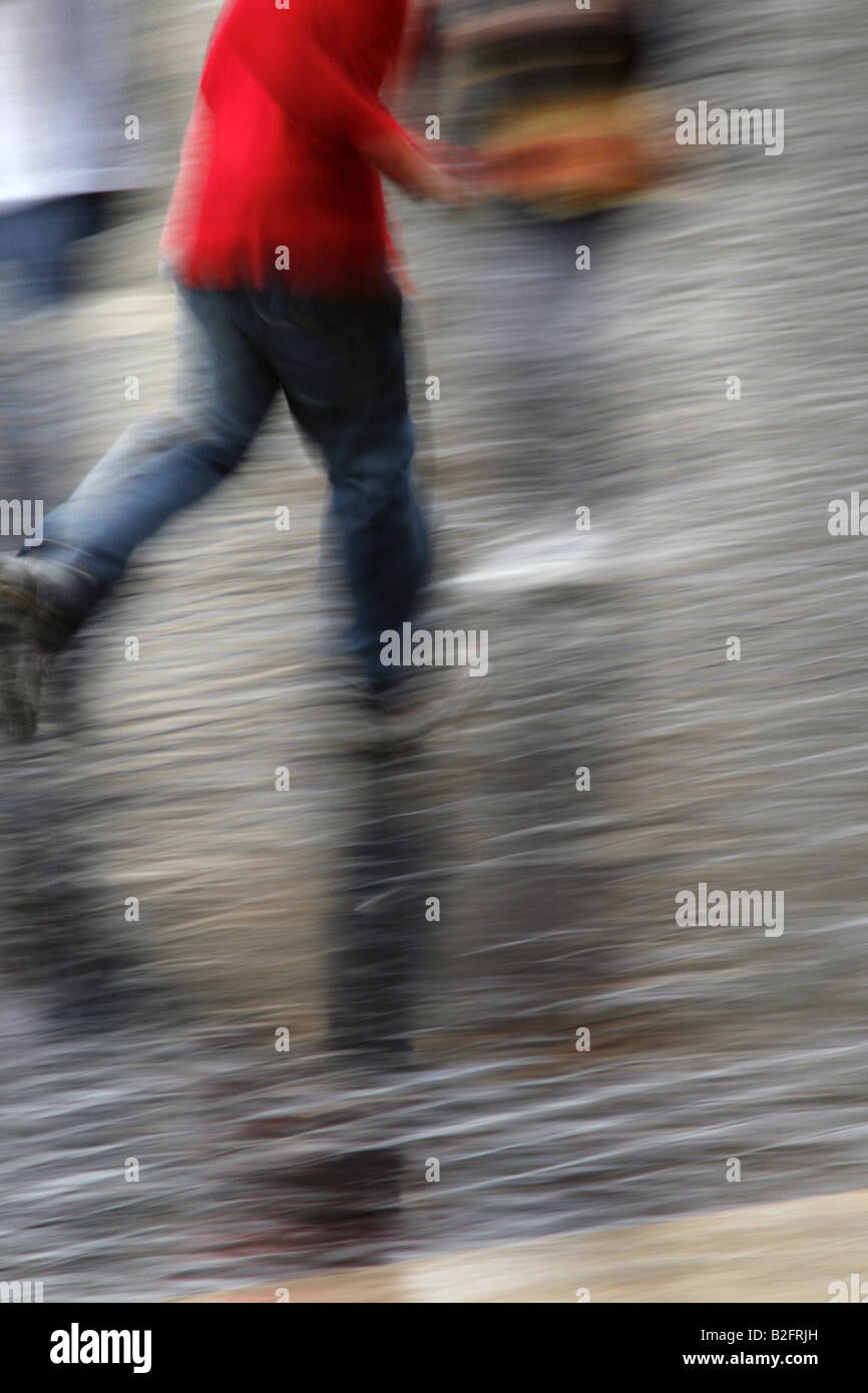 one person running fast in rain in town Stock Photo - Alamy