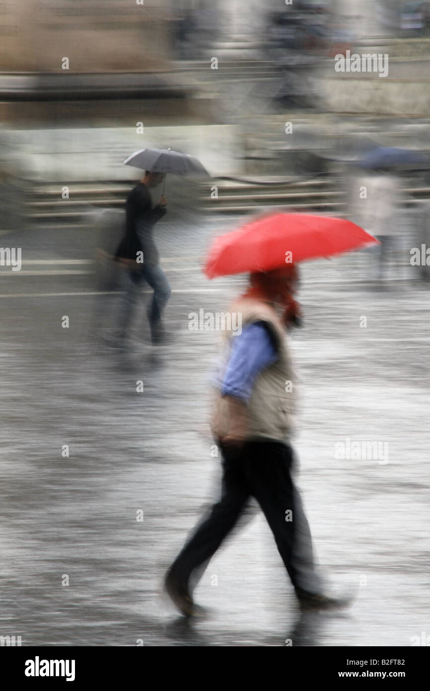 man with umbrella running in heavy rain in town Stock Photo - Alamy