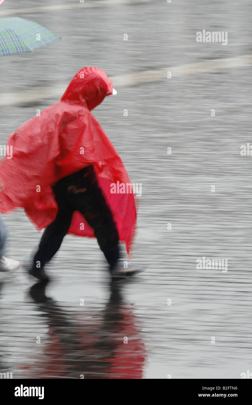 person wearing waterproof coat cape in rain Stock Photo - Alamy