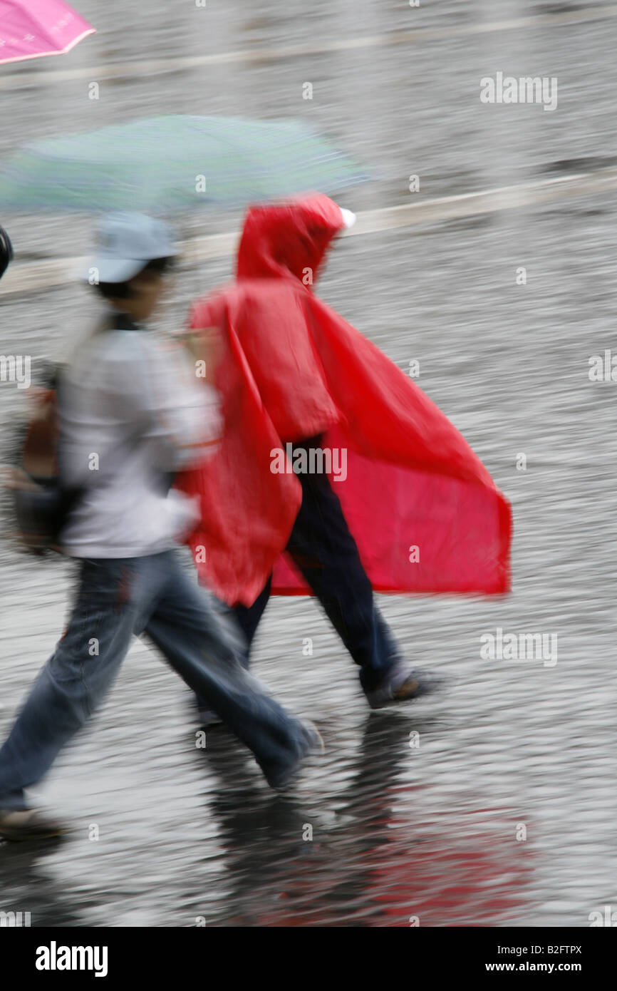 people wearing waterproof coat capes in rain Stock Photo - Alamy