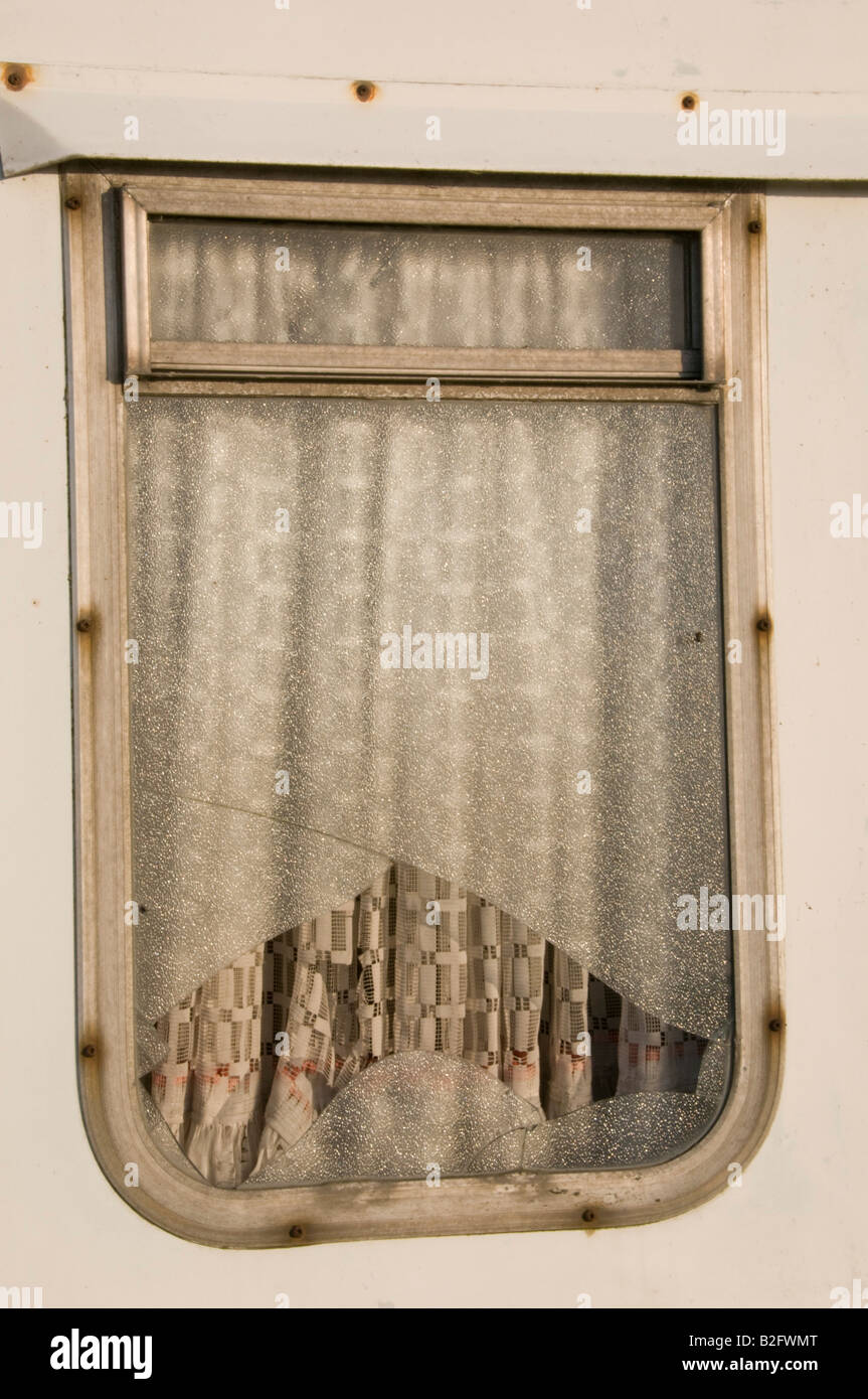 Broken window on a disused caravan Stock Photo - Alamy
