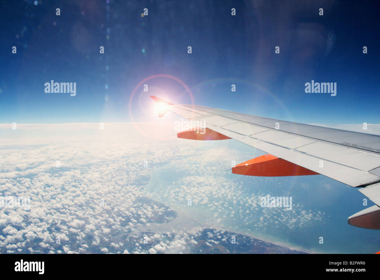 Aircraft window view with lens flare Stock Photo - Alamy