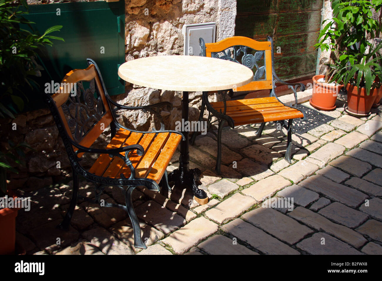 Chairs and small table in front of the house Stock Photo - Alamy