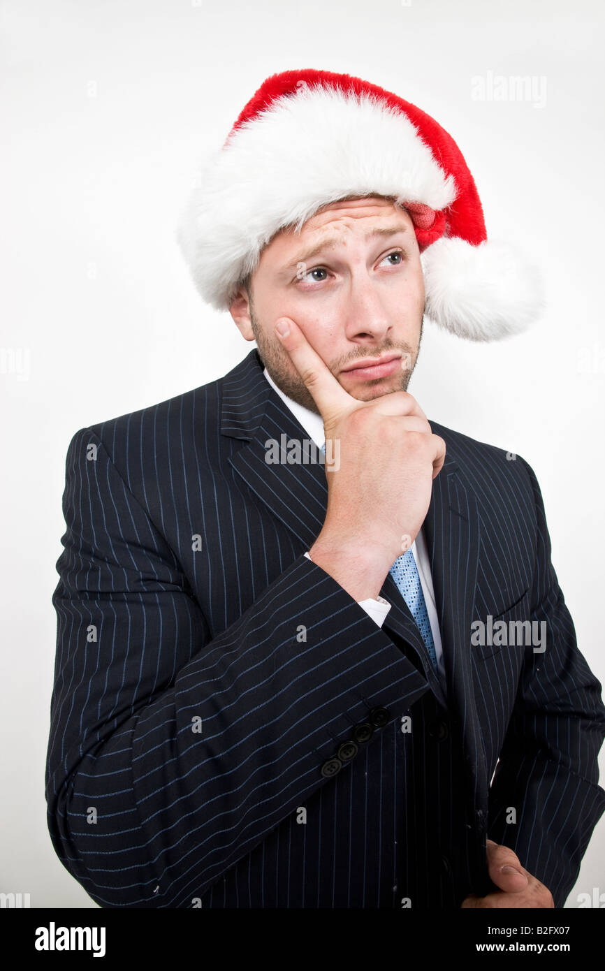 thinking businessman with Santa cap Stock Photo - Alamy