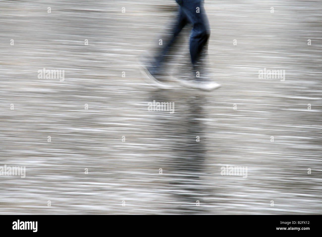 person running on wet street in rain in town Stock Photo - Alamy