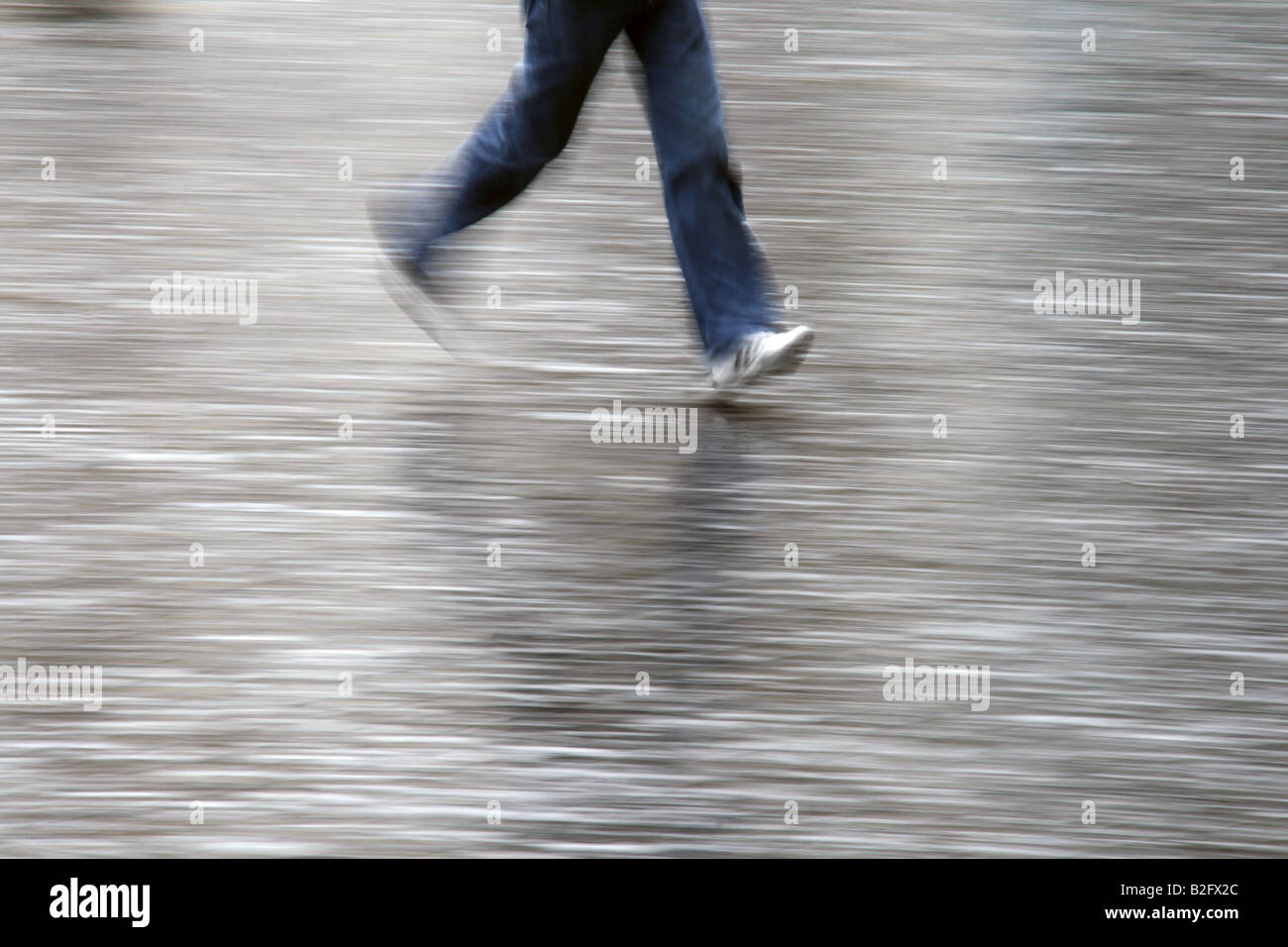 person running on wet street in rain in town Stock Photo - Alamy