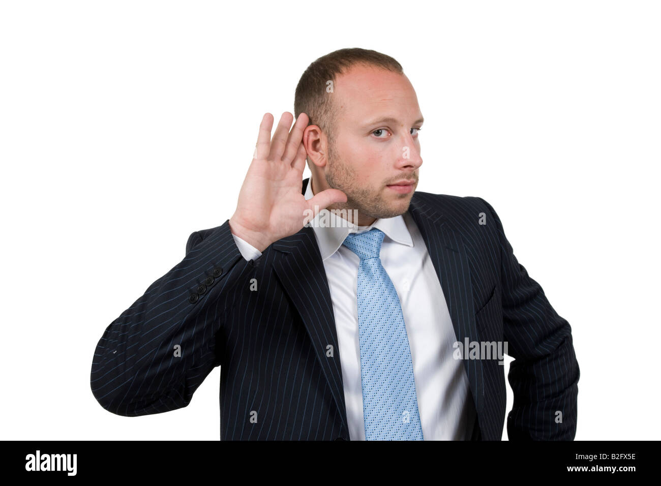listening businessman holding his hand up towards his ear in a paying ...