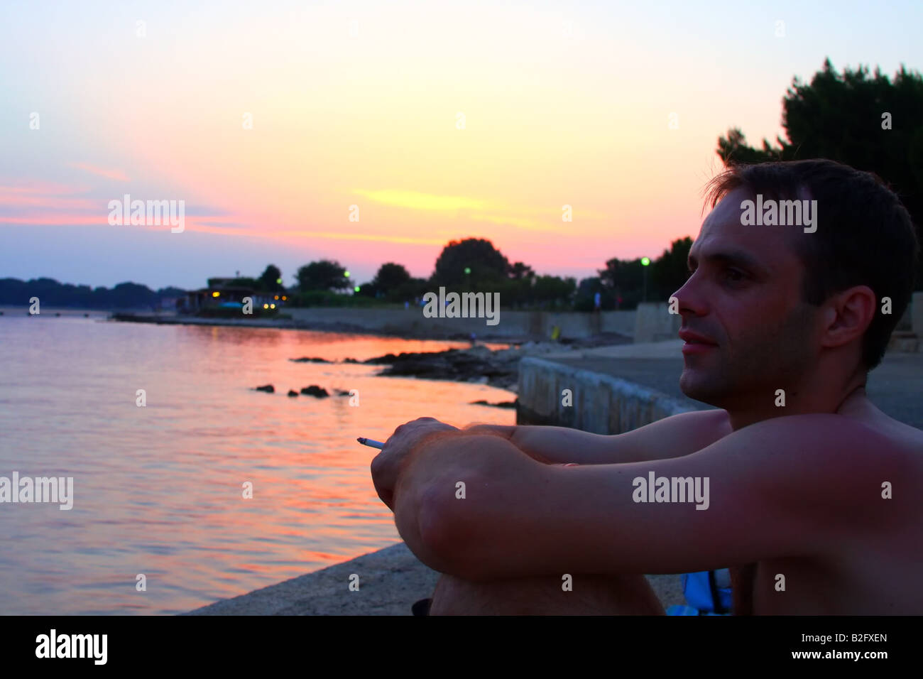 Smokeing in the sunset Stock Photo - Alamy