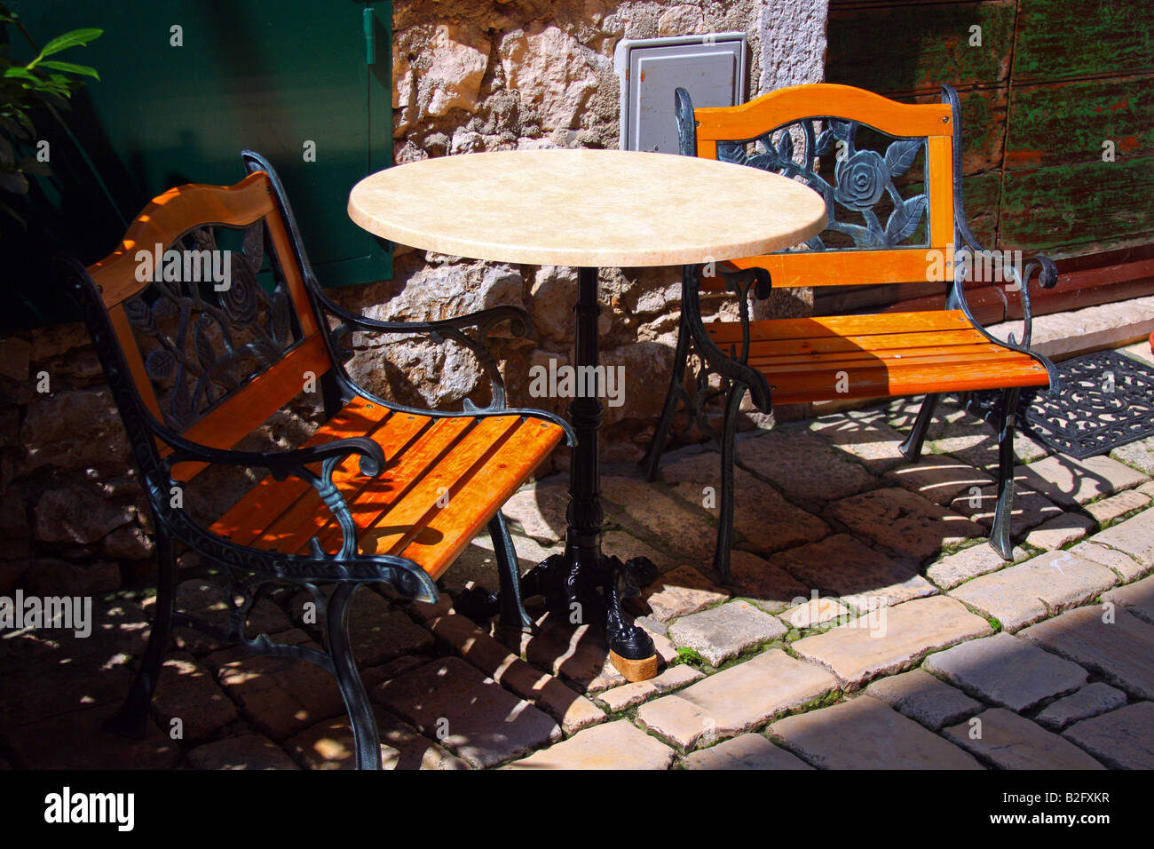 Chairs and small table in front of the house Stock Photo - Alamy