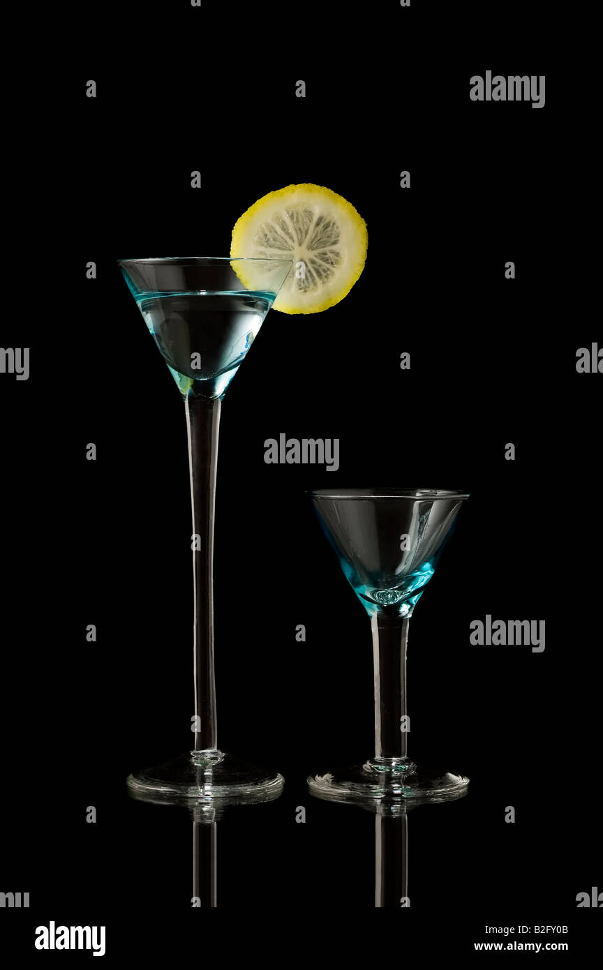 Long drink concept. Long cocktail stem glass with a slice of lemon and ...