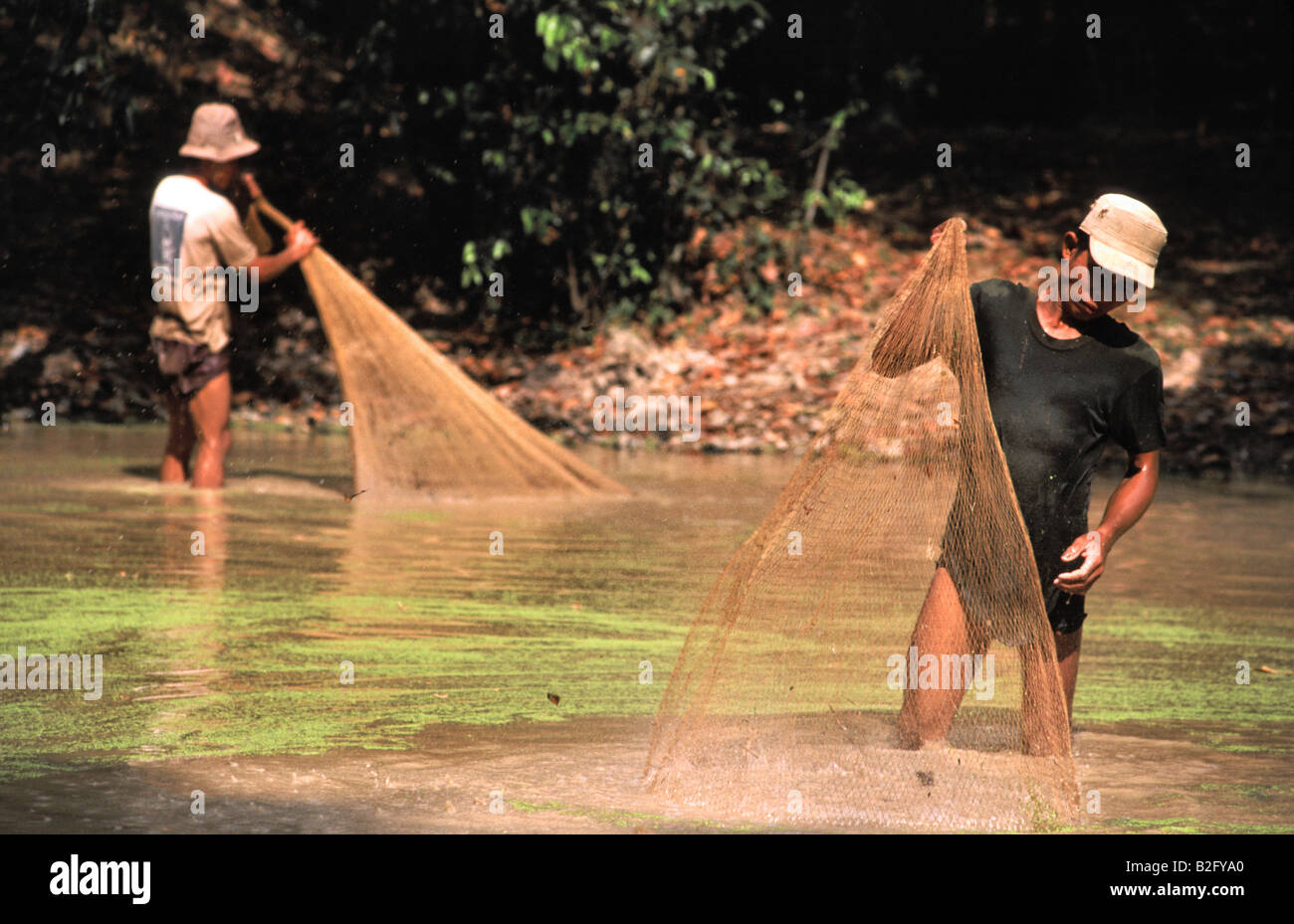 Two men with empty fishing nets Stock Photo - Alamy