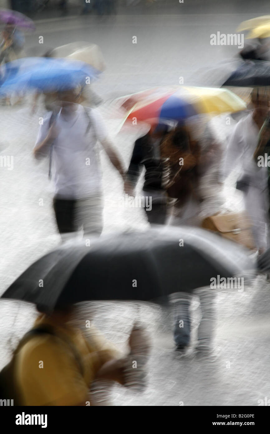 people with umbrellas in heavy rain in town Stock Photo - Alamy