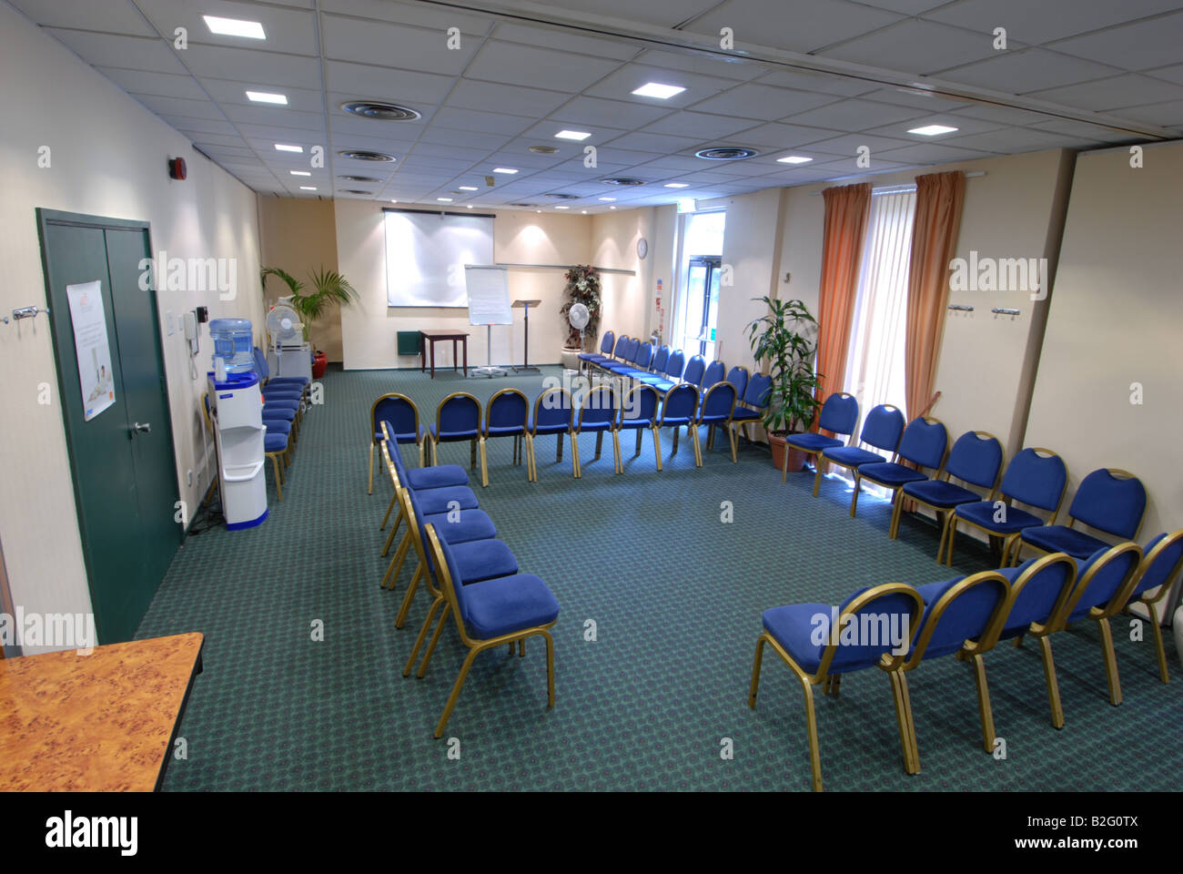 large empty meeting room with chairs laid out in a square ready for a ...