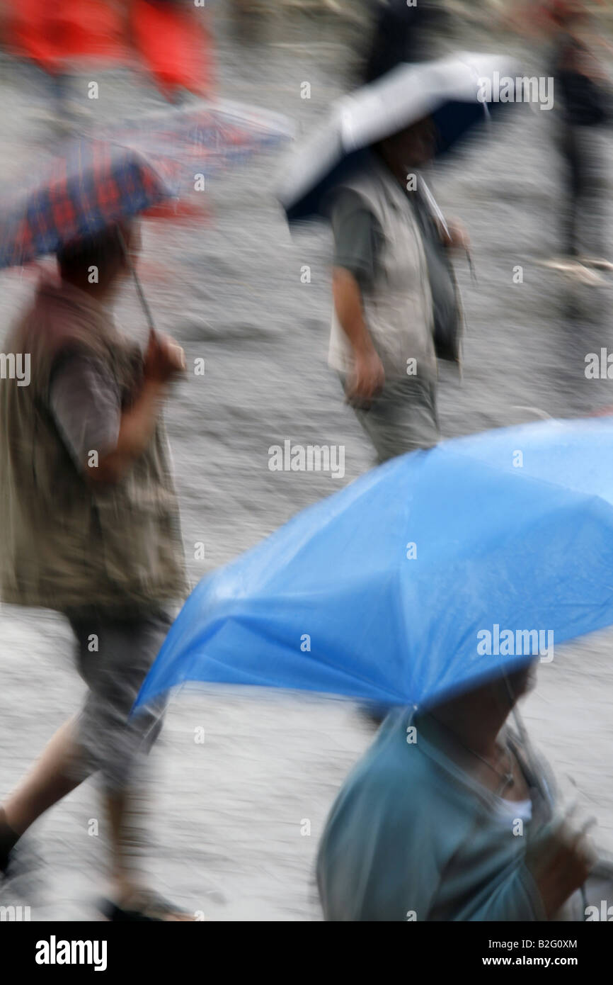 crowd of people with umbrellas in heavy rain in city town Stock Photo ...
