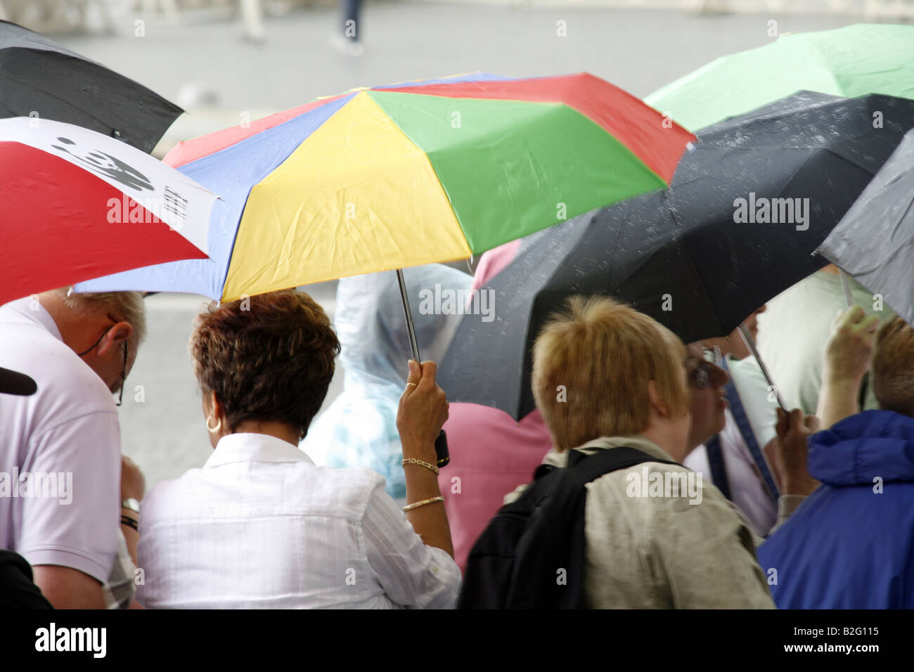 people with umbrellas in heavy rain in town Stock Photo - Alamy