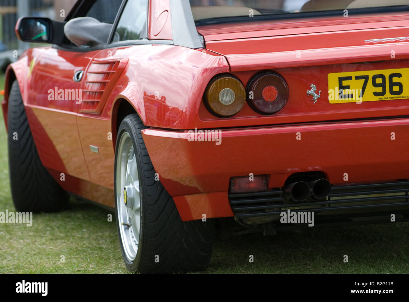 Red Ferrari driving on grass at Motor Show Stock Photo - Alamy