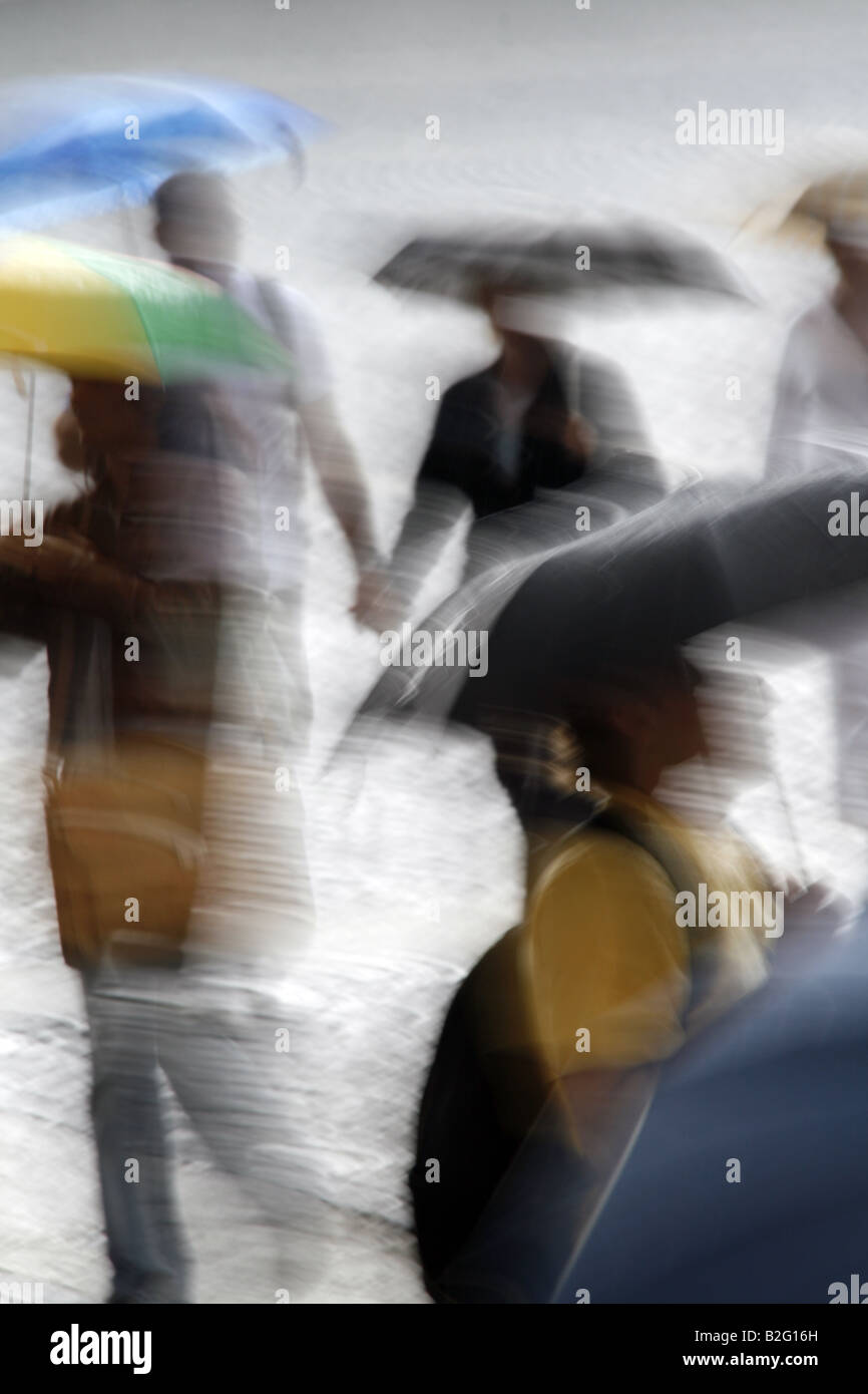 people with umbrellas in heavy rain in town Stock Photo - Alamy