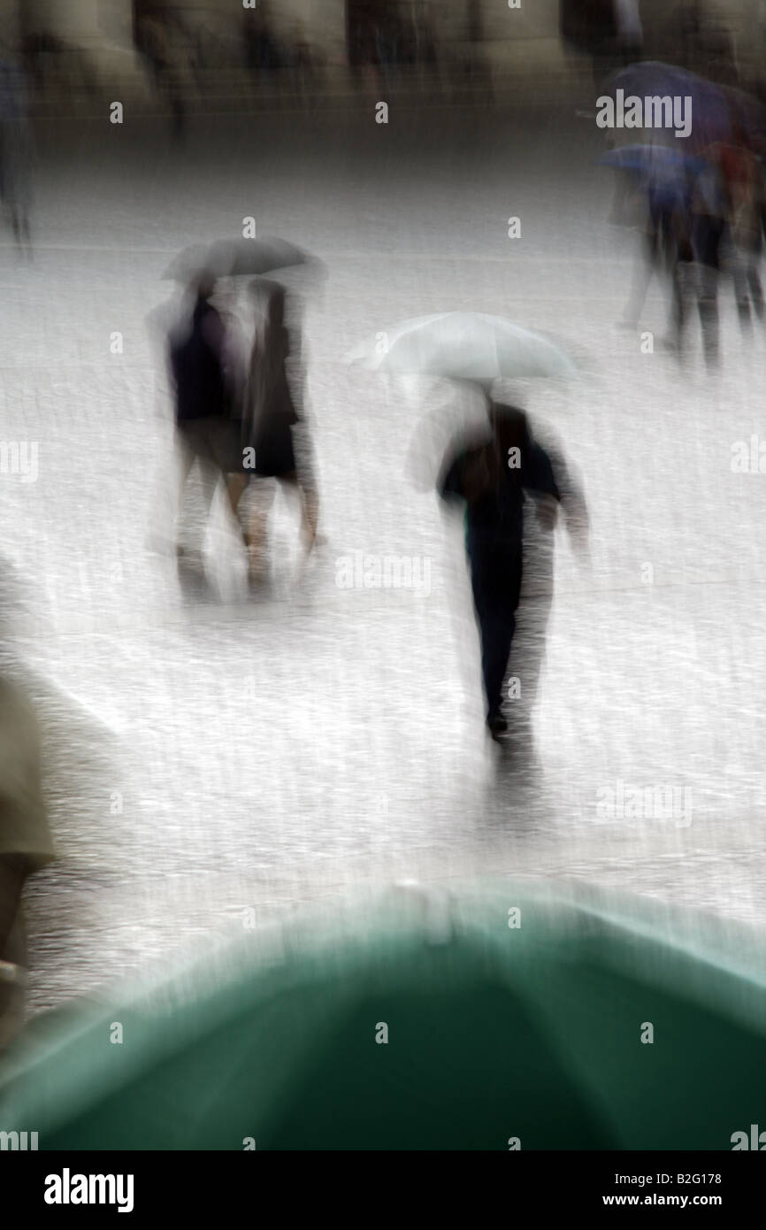 people with umbrellas in heavy rain in town Stock Photo - Alamy