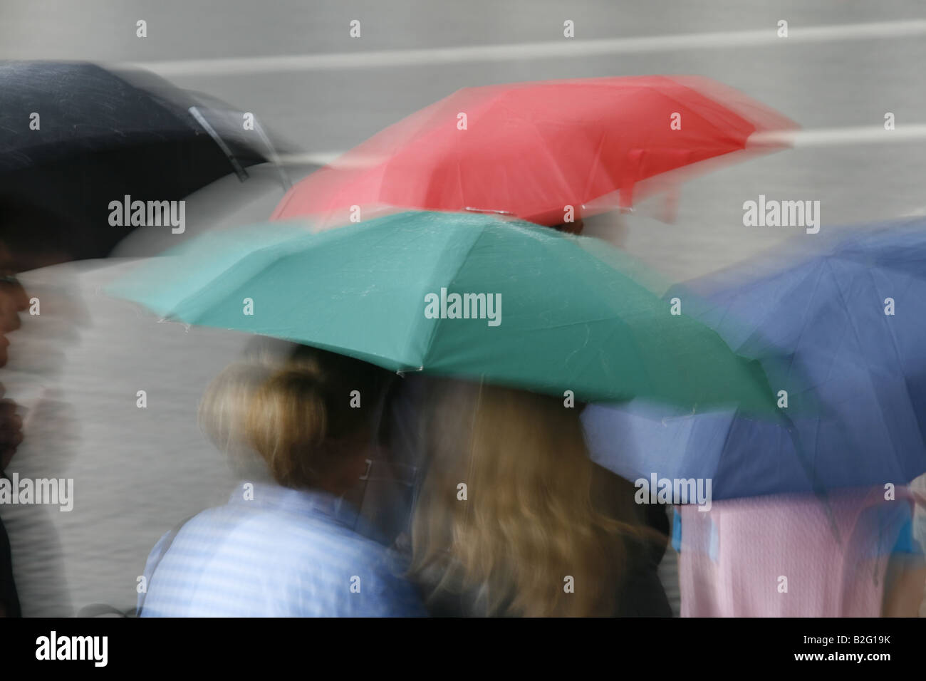 crowd of people with umbrellas in rain in town Stock Photo - Alamy