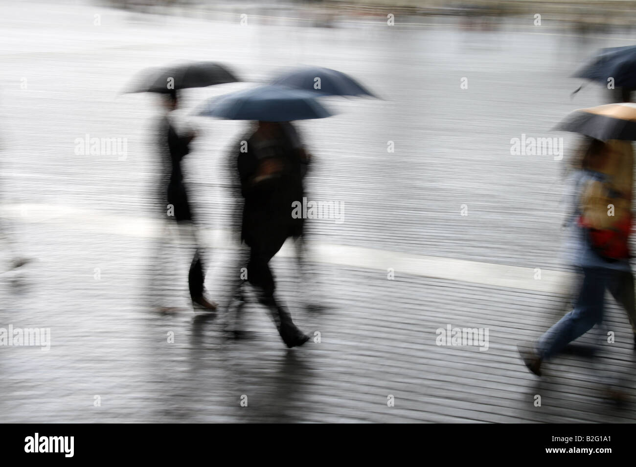 people with umbrellas in heavy rain in town Stock Photo - Alamy