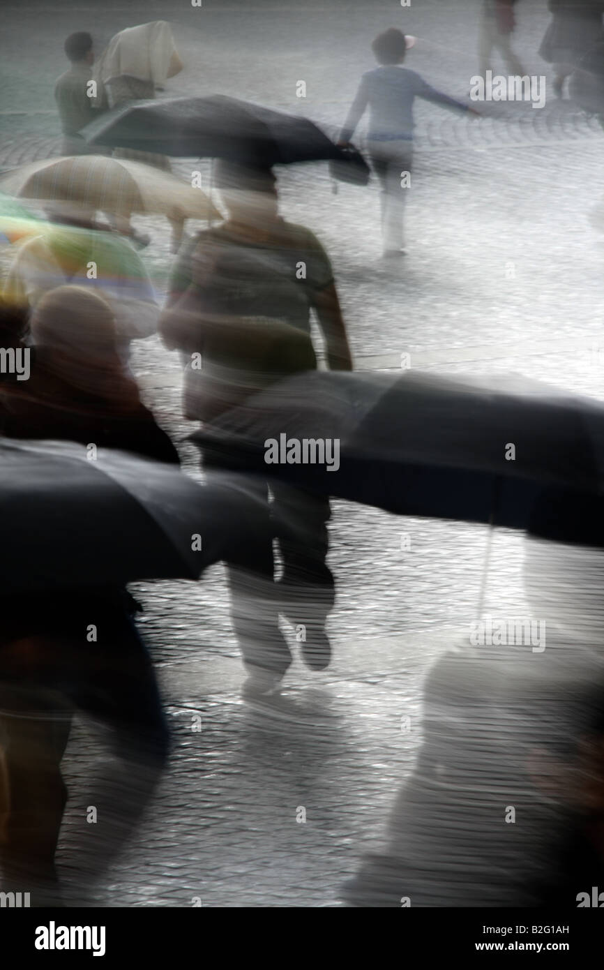 people with umbrellas in heavy rain in town Stock Photo - Alamy