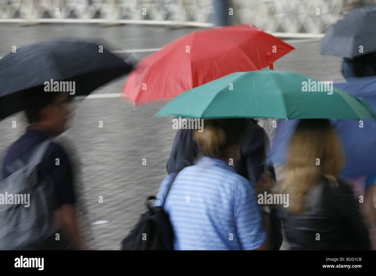 crowd of people with umbrellas in rain in town Stock Photo - Alamy
