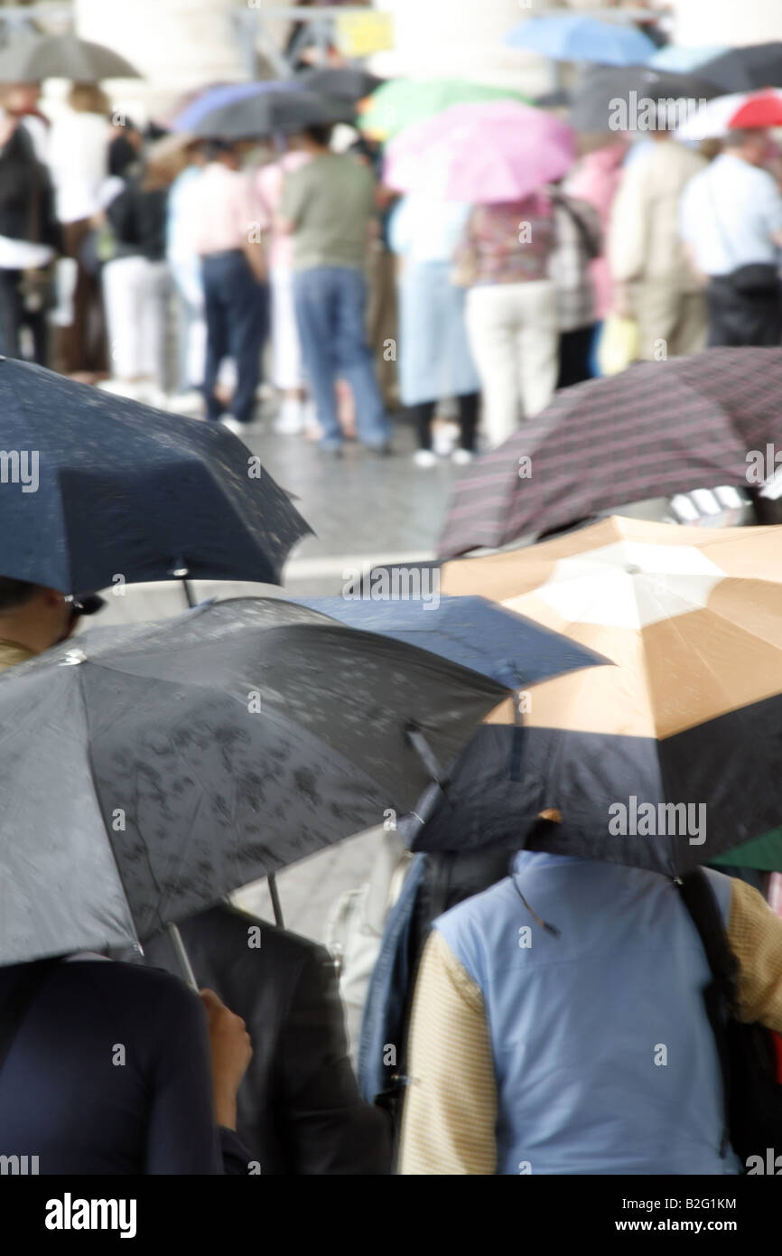 crowd of people with umbrellas in rain in town Stock Photo - Alamy