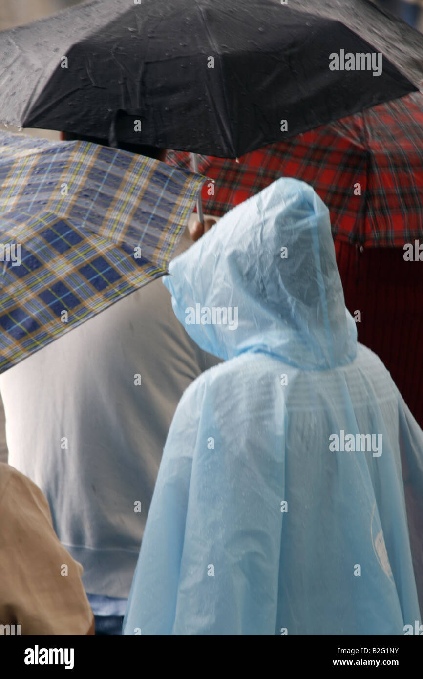 people with umbrellas in heavy rain in town Stock Photo - Alamy