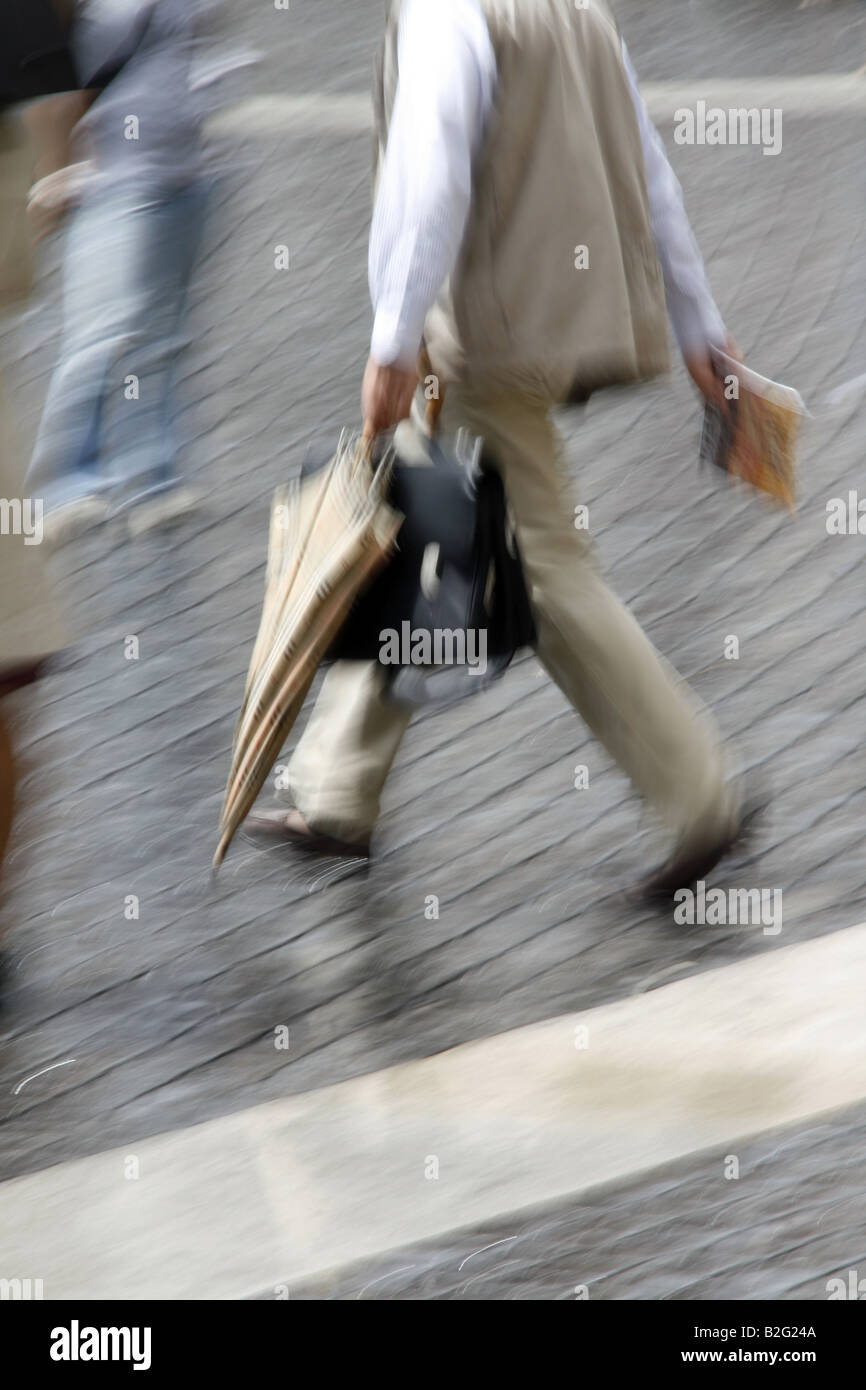 person carrying closed umbrella in town Stock Photo - Alamy