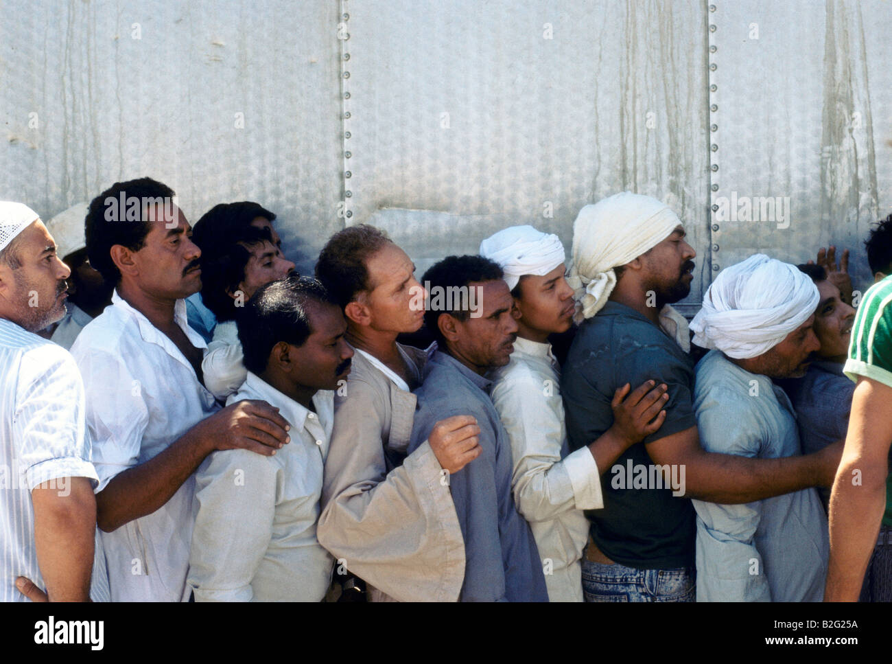jordanian men queue for bread hand out in refugee camp during the gulf ...