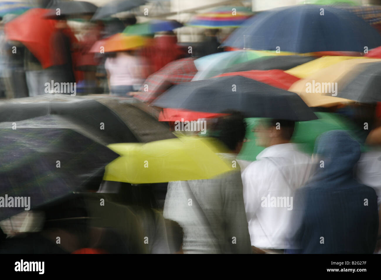 crowd of people with umbrellas in rain in town Stock Photo - Alamy
