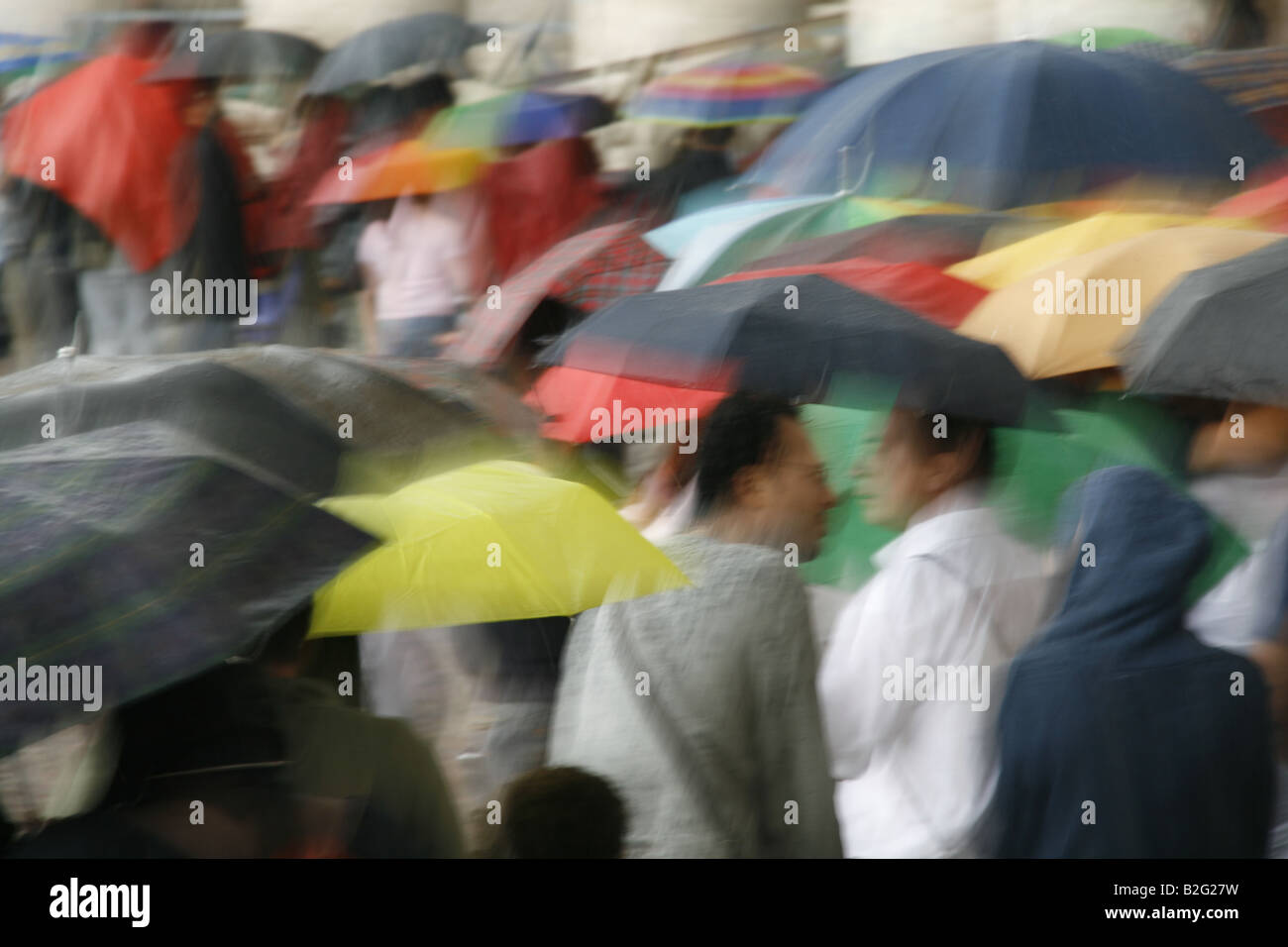 crowd of people with umbrellas in rain in town Stock Photo - Alamy