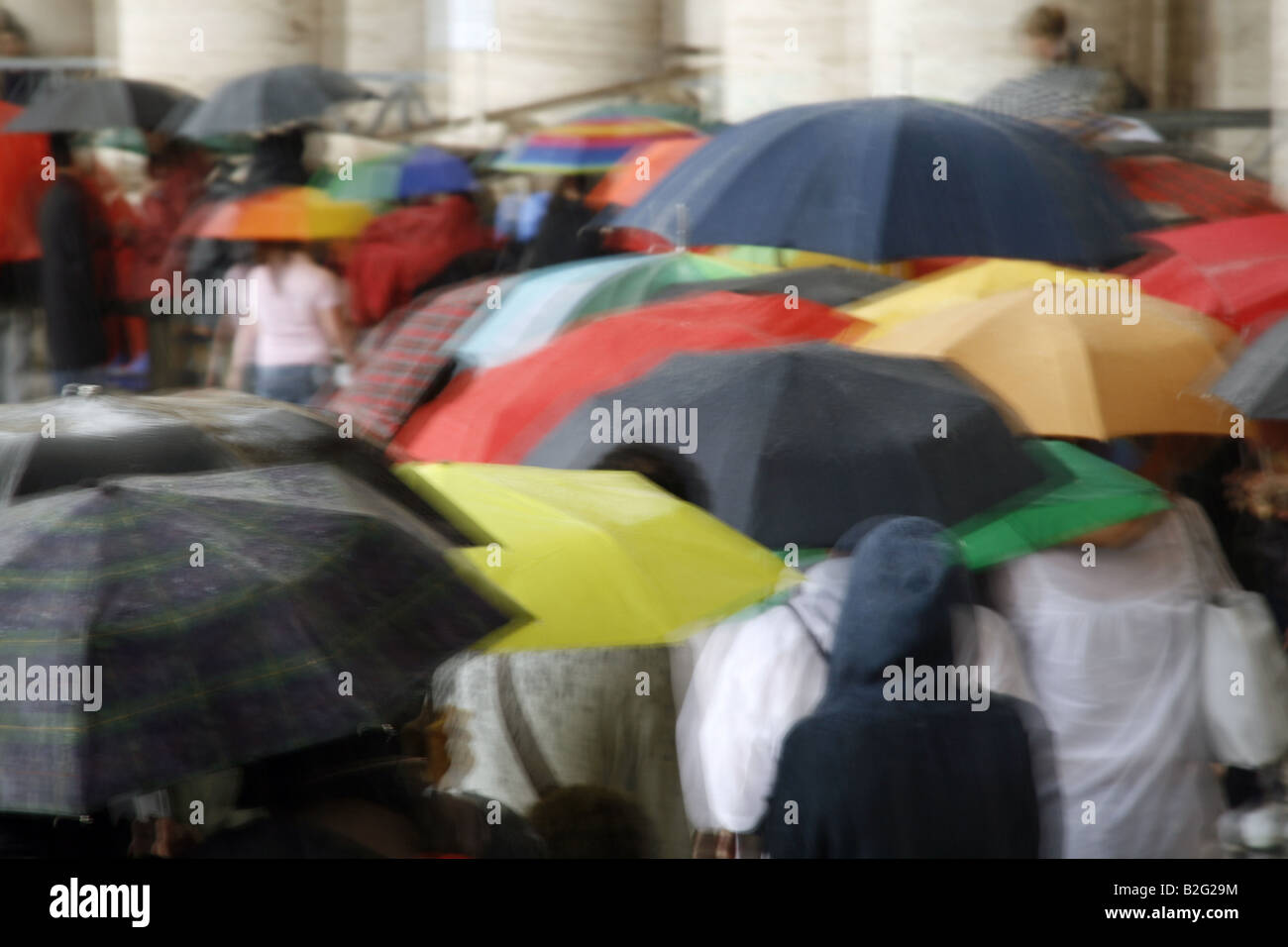 crowd of people with umbrellas in rain in town Stock Photo - Alamy