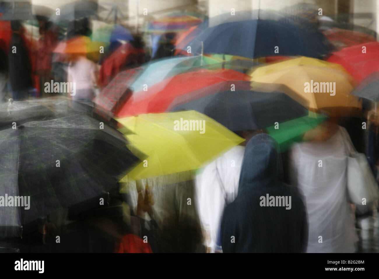 crowd of people with umbrellas in rain in town Stock Photo - Alamy