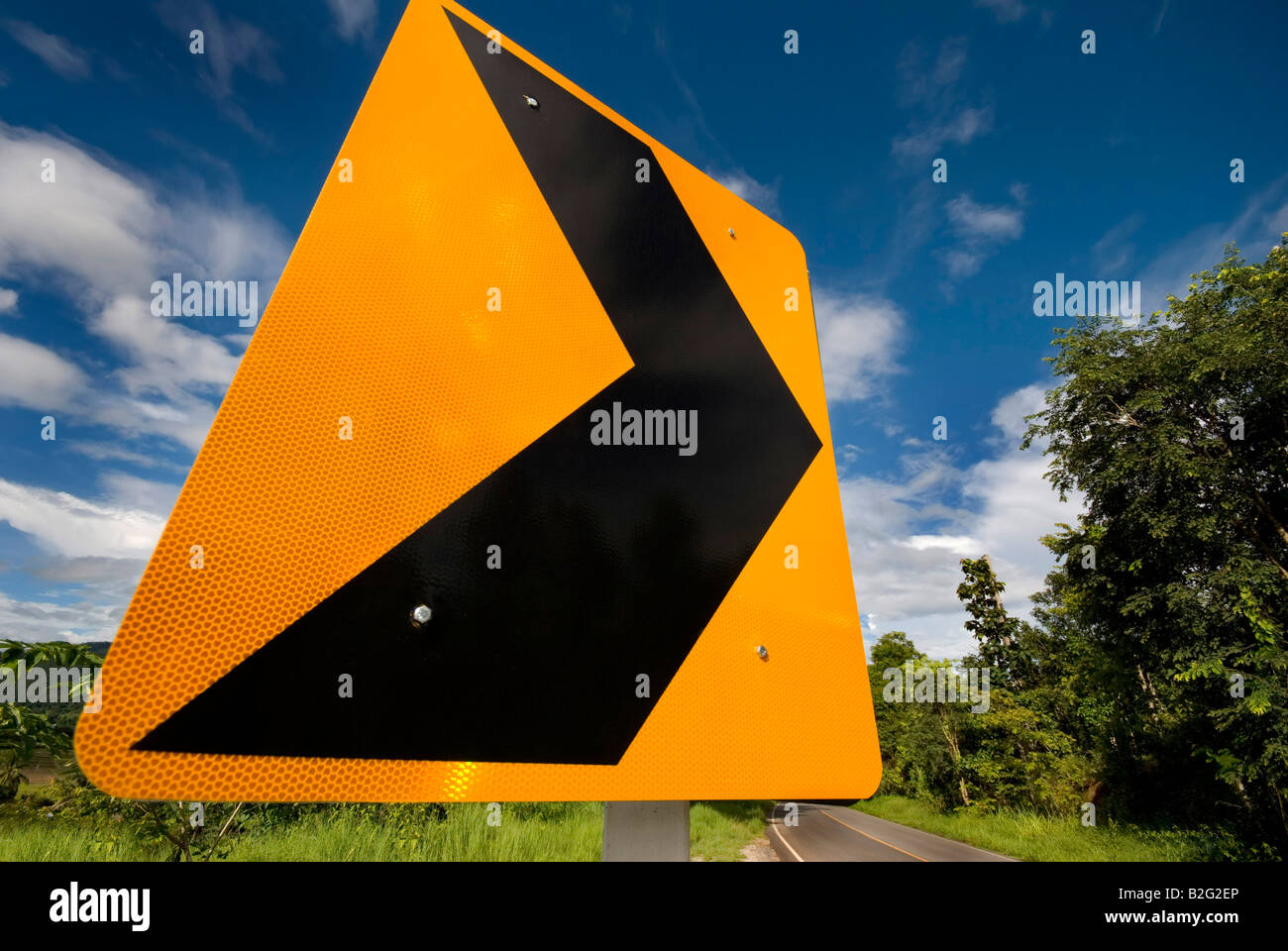 Yellow road sign indicating a right turn curve ahead wide angle image ...