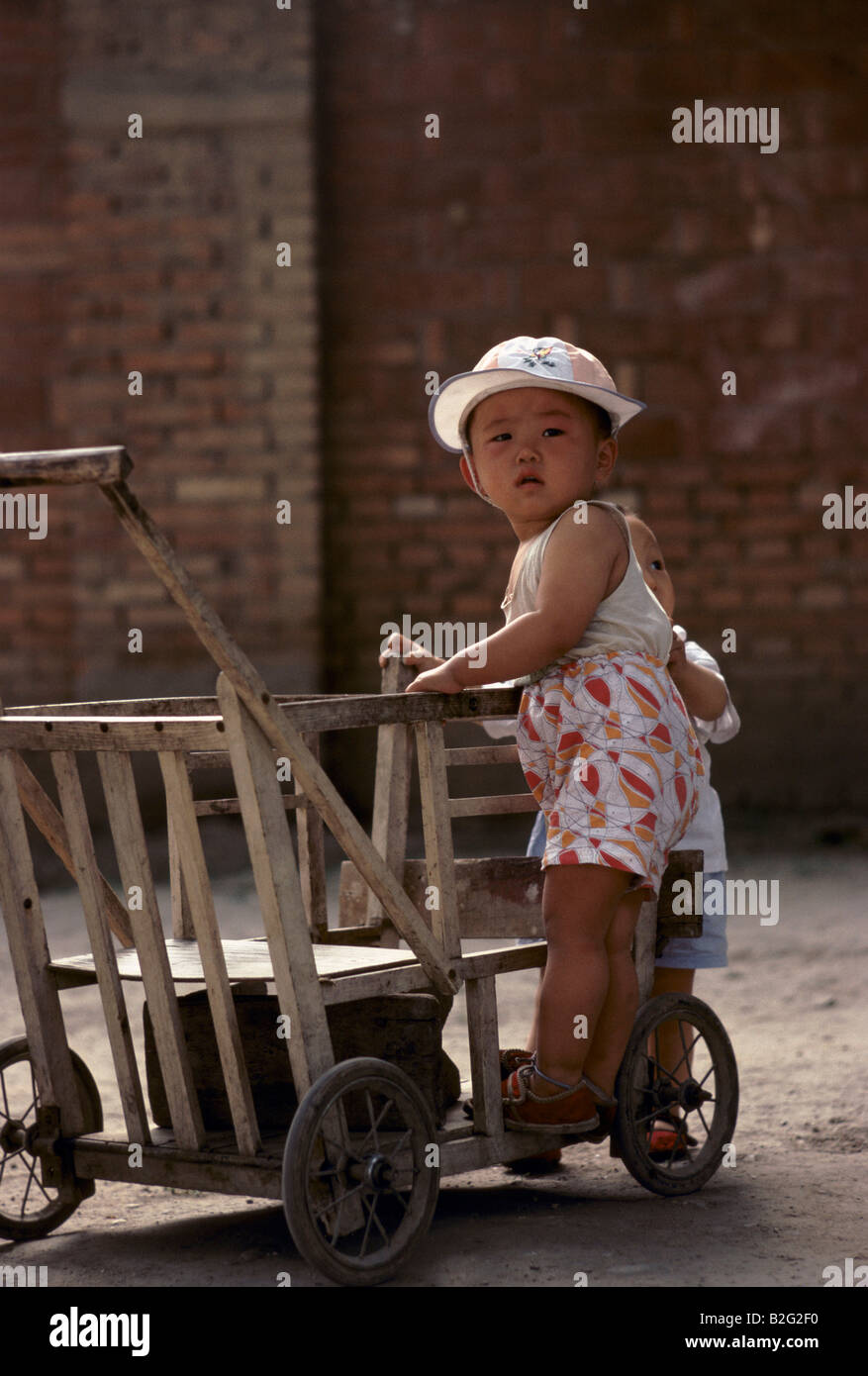 little girl with wooden cart Stock Photo - Alamy