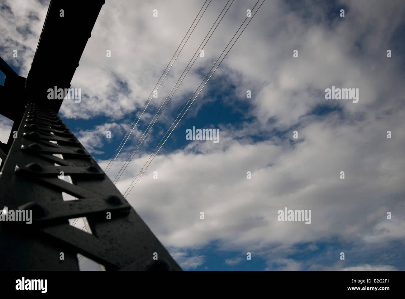 An old steel bridge structure and new electric cables cross in an ...