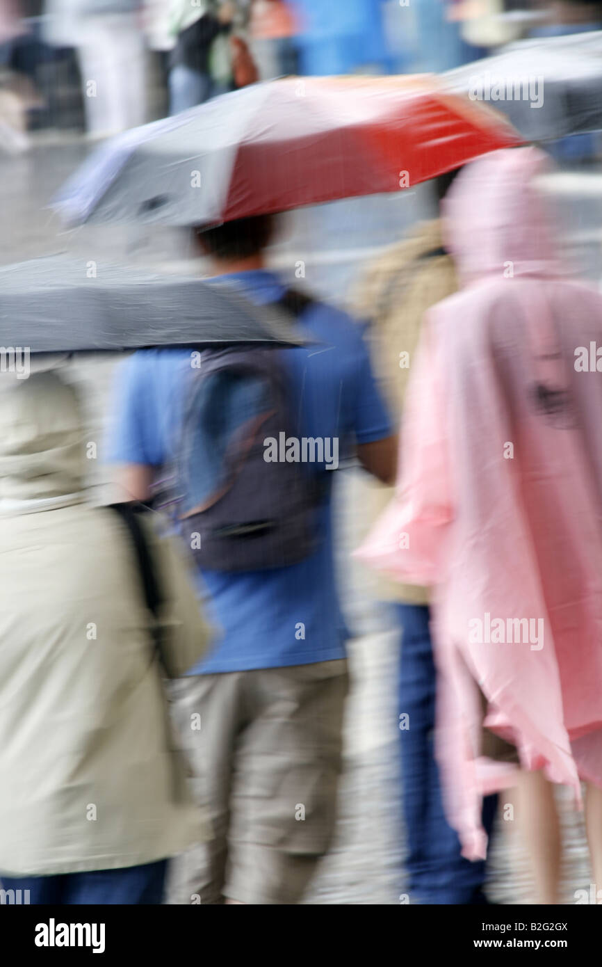 people with umbrellas in heavy rain in town Stock Photo - Alamy