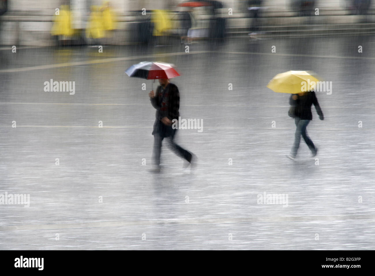 people with umbrellas in heavy rain in town Stock Photo - Alamy