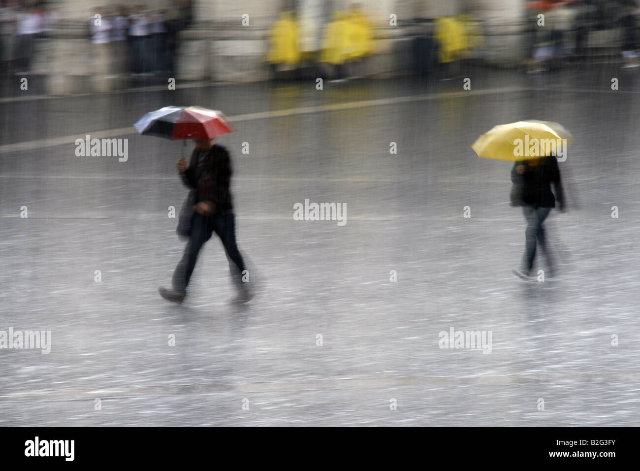 people with umbrellas in heavy rain in town Stock Photo - Alamy