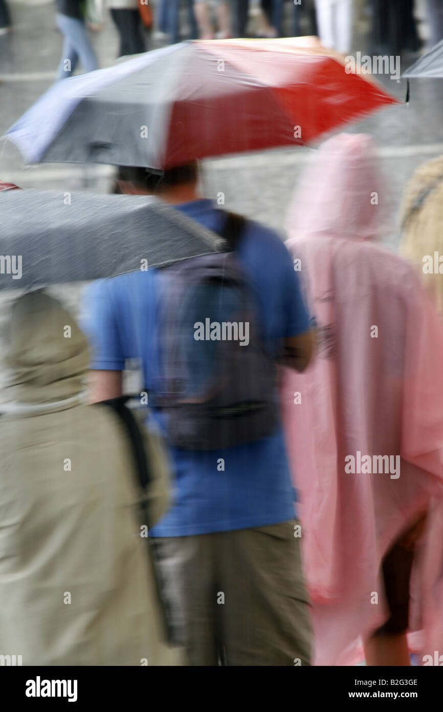people with umbrellas in heavy rain in town Stock Photo - Alamy