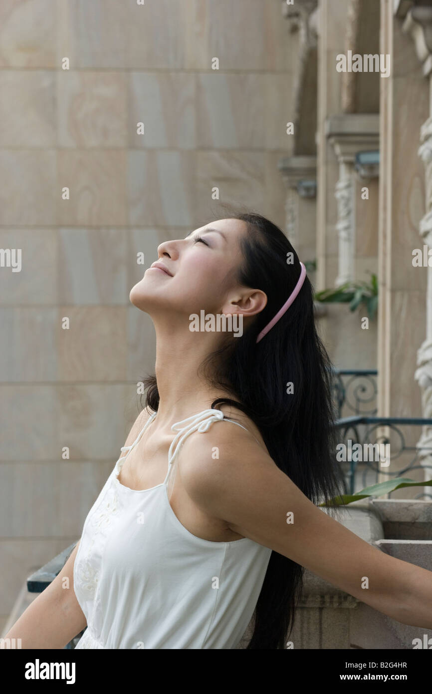 Side profile of a woman standing in a balcony hi-res stock photography ...