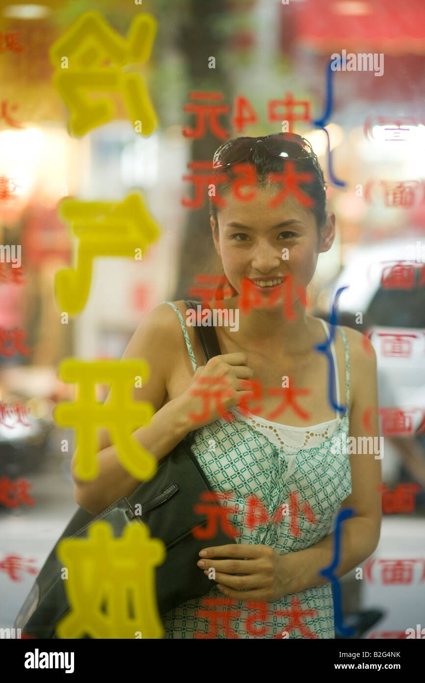 Young woman looking at a window display Stock Photo - Alamy