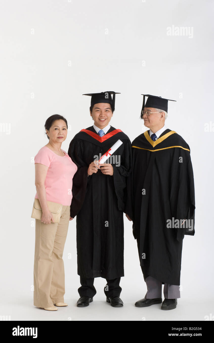 Parents Standing With Their Graduate Son High Resolution Stock ...