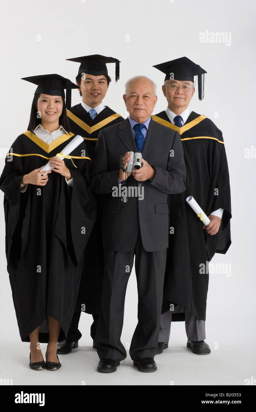 Portrait of three university students standing with their professor ...